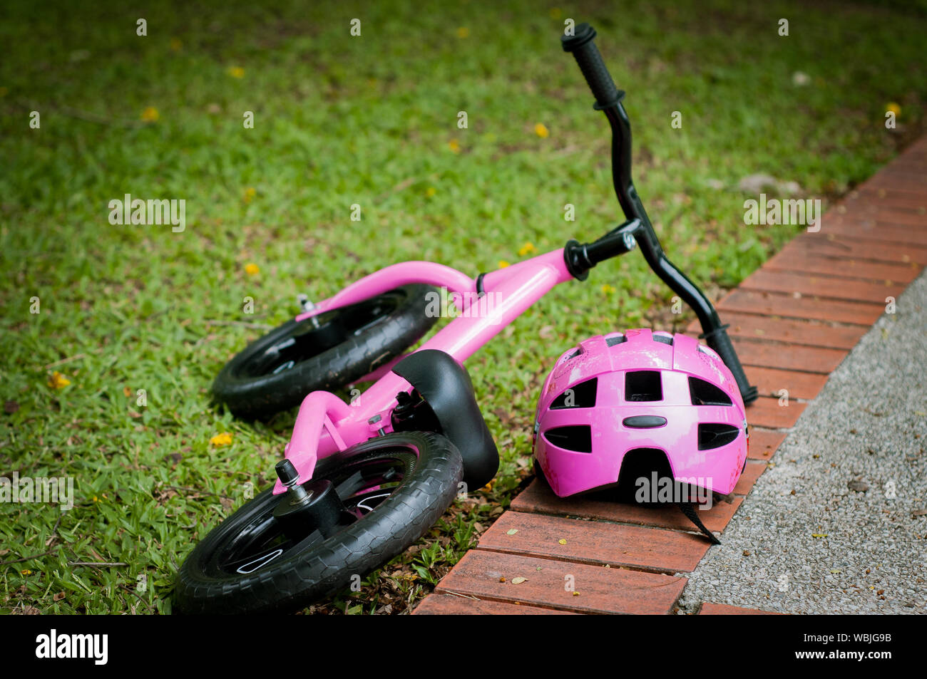 Pink bike for little girl. A pink bike parking in the park near the ...