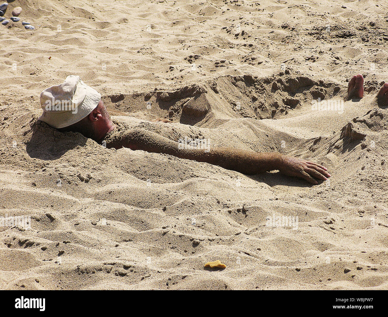 Buried on beach hi-res stock photography and images - Alamy