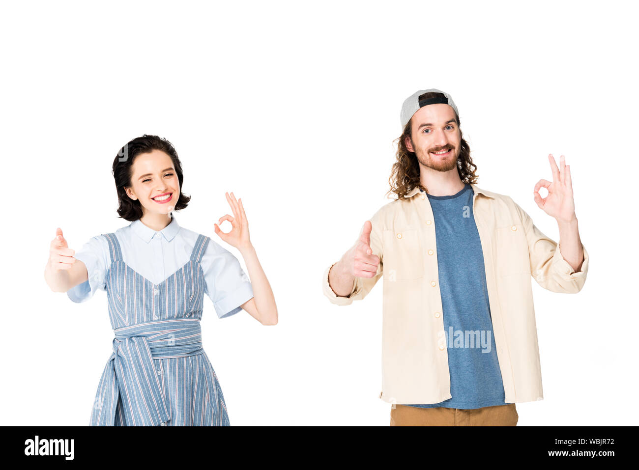 two people pointing with fingers at camera and showing OK signs ...