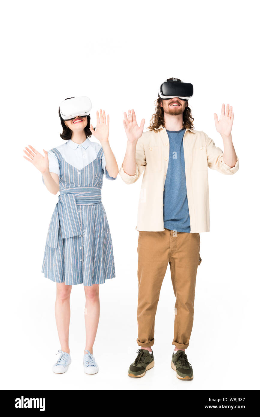 full length view of two people with VR headset raising hands in air ...