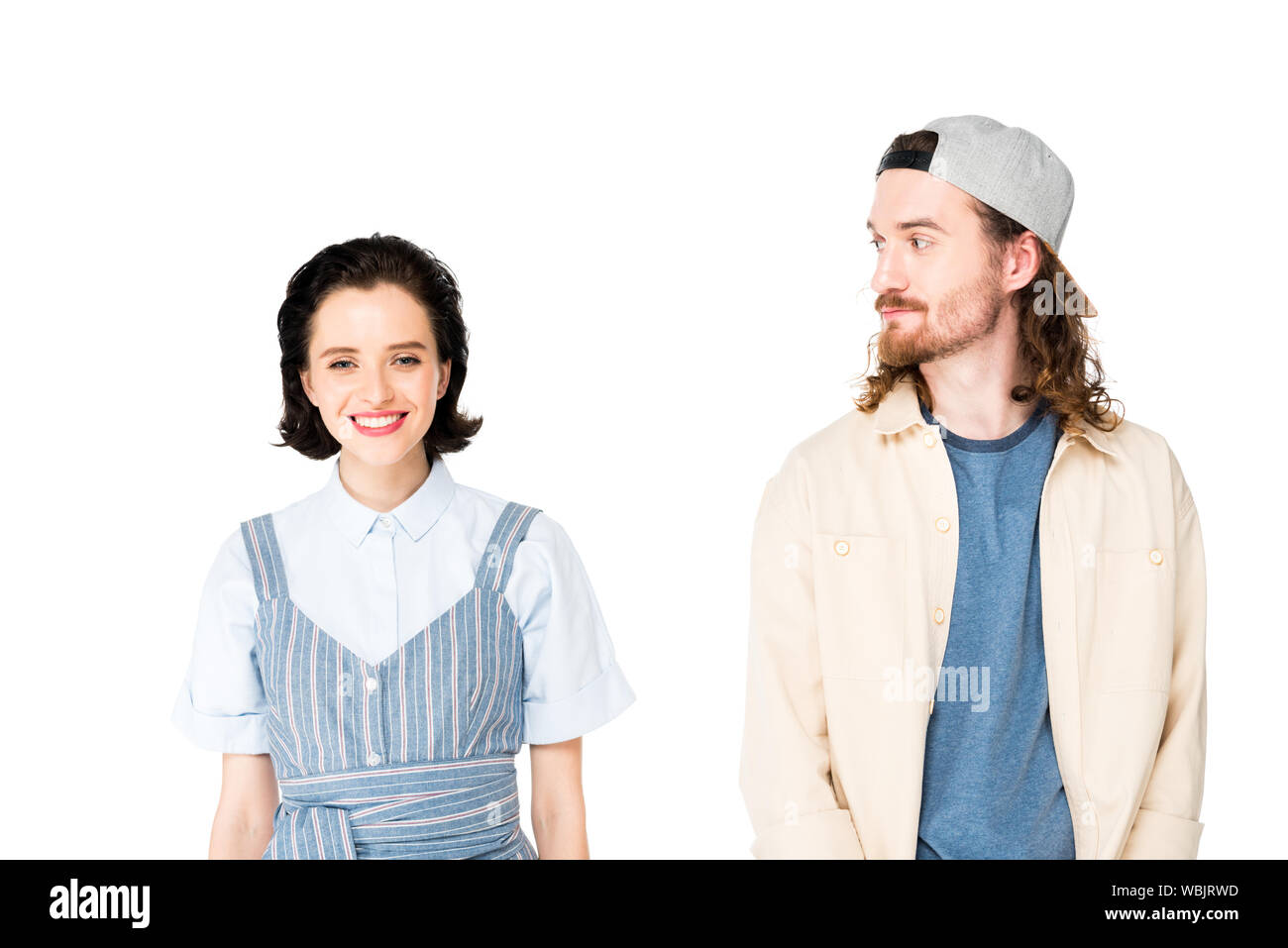beautiful girl looking at camera and smiling while young man looking at ...