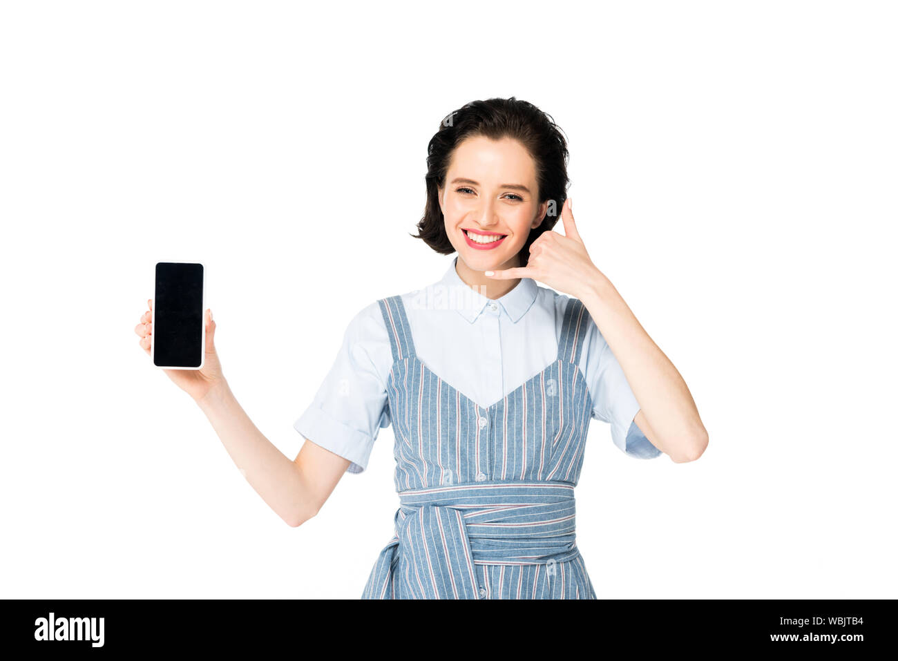 girl holding smartphone in hand, smiling and showing call me sign at ...
