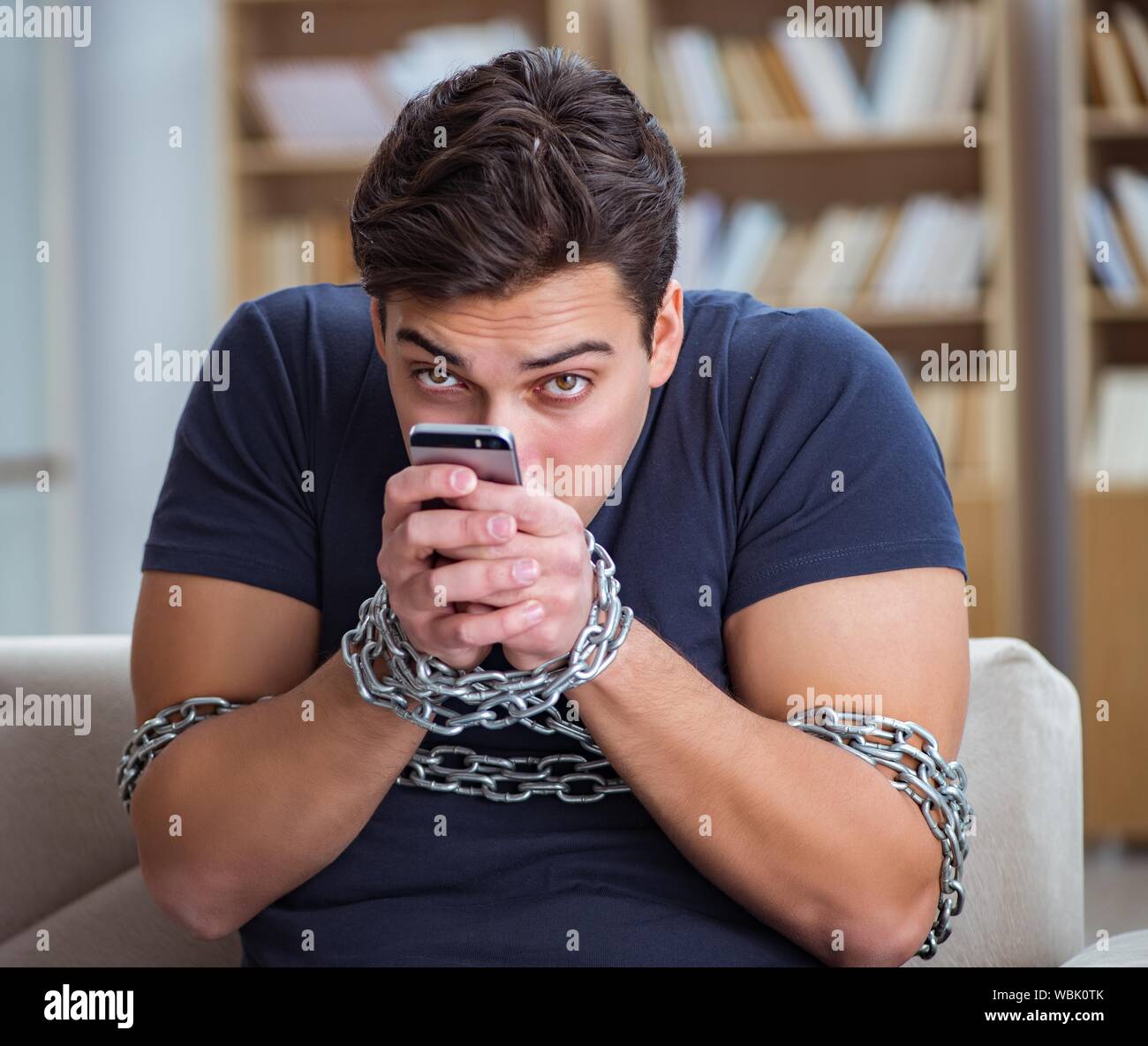 The man suffering from phone dependence addiction Stock Photo - Alamy