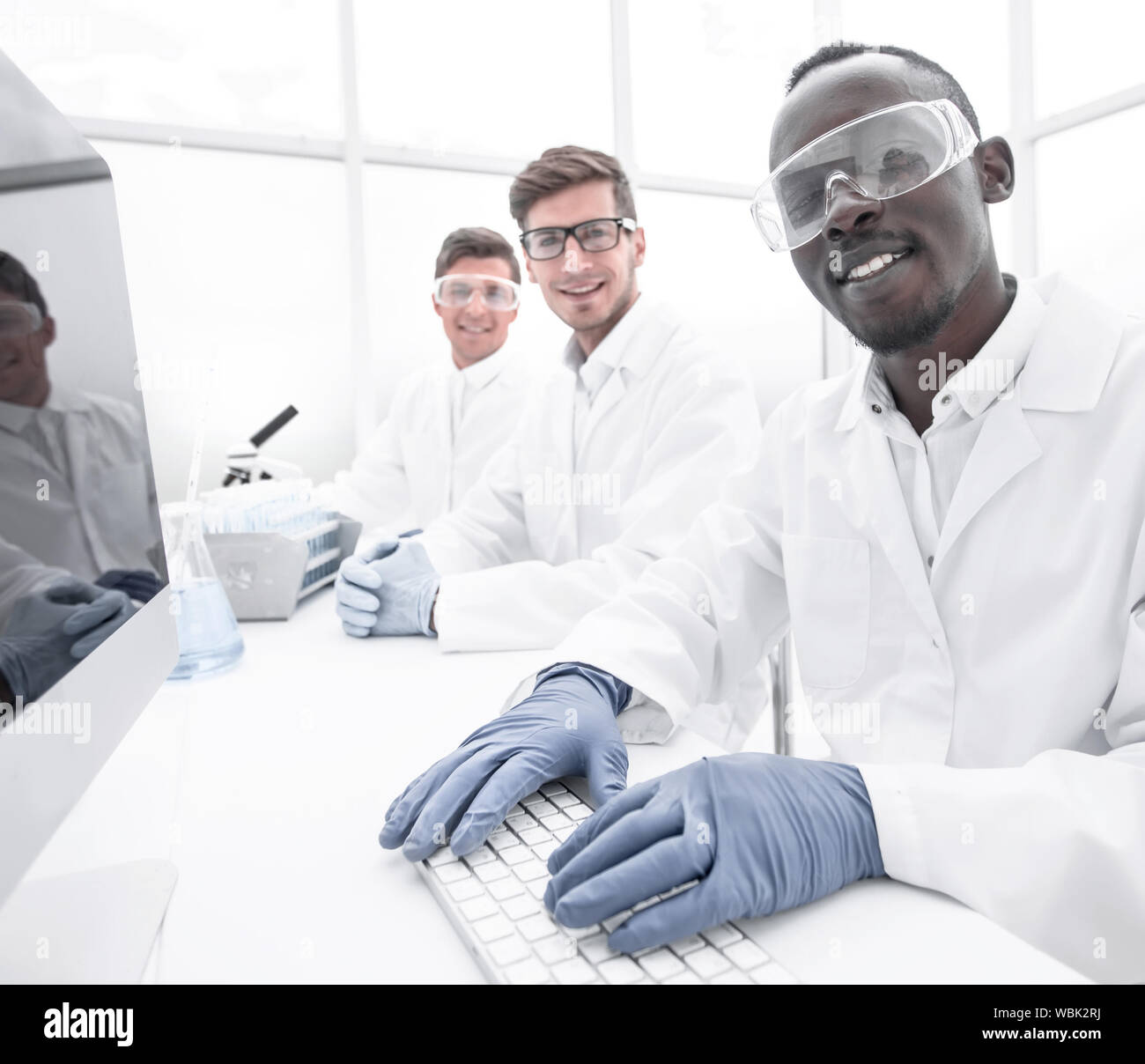group of scientists sitting at the laboratory table Stock Photo - Alamy