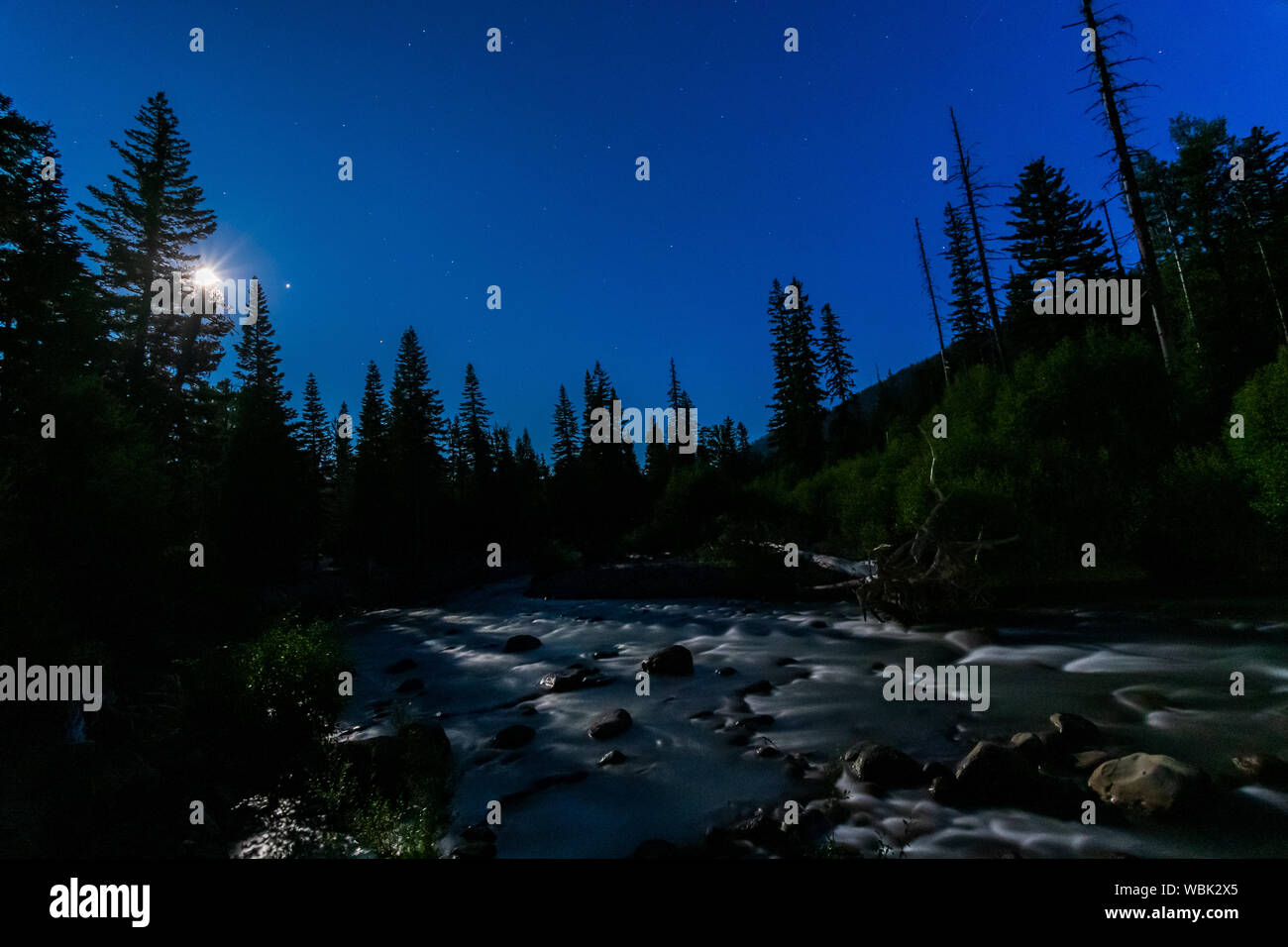 Full Moon Shines On Flowing River Stock Photo - Alamy