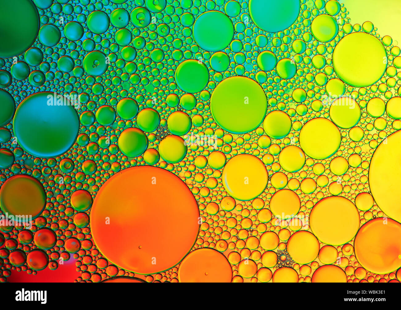 Multi-coloured bubble patterns formed by oil floating on water Stock ...