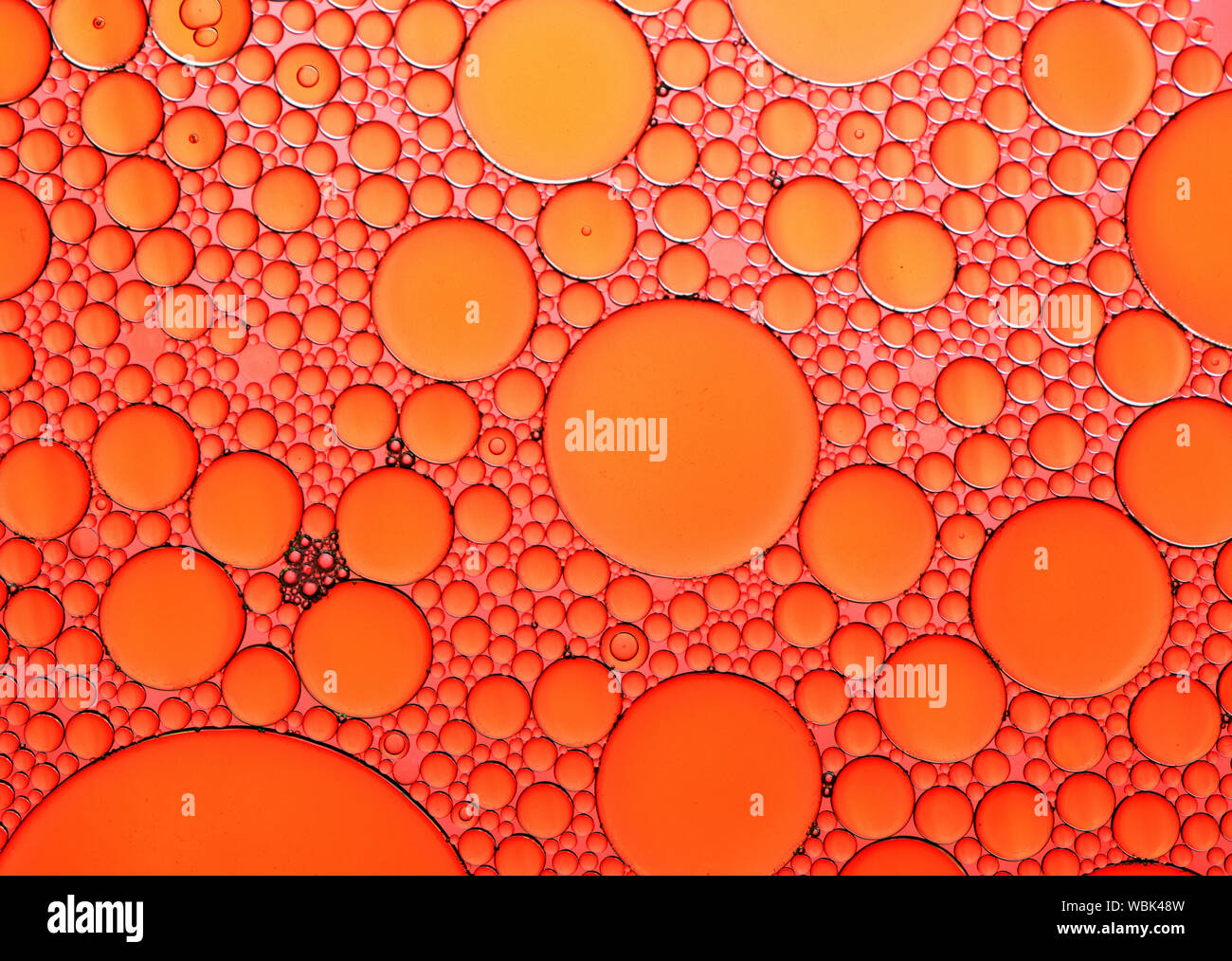Multi-coloured bubble patterns formed by oil floating on water Stock ...
