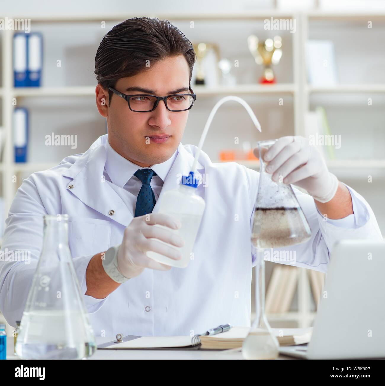 Young researcher scientist doing a water test contamination experiment ...