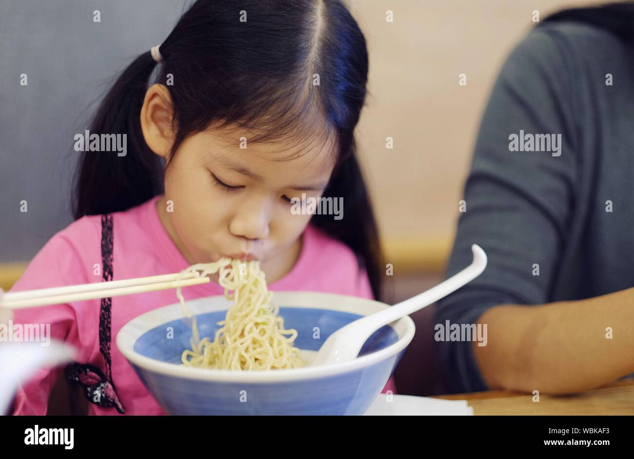 Girl eating table hi-res stock photography and images - Alamy