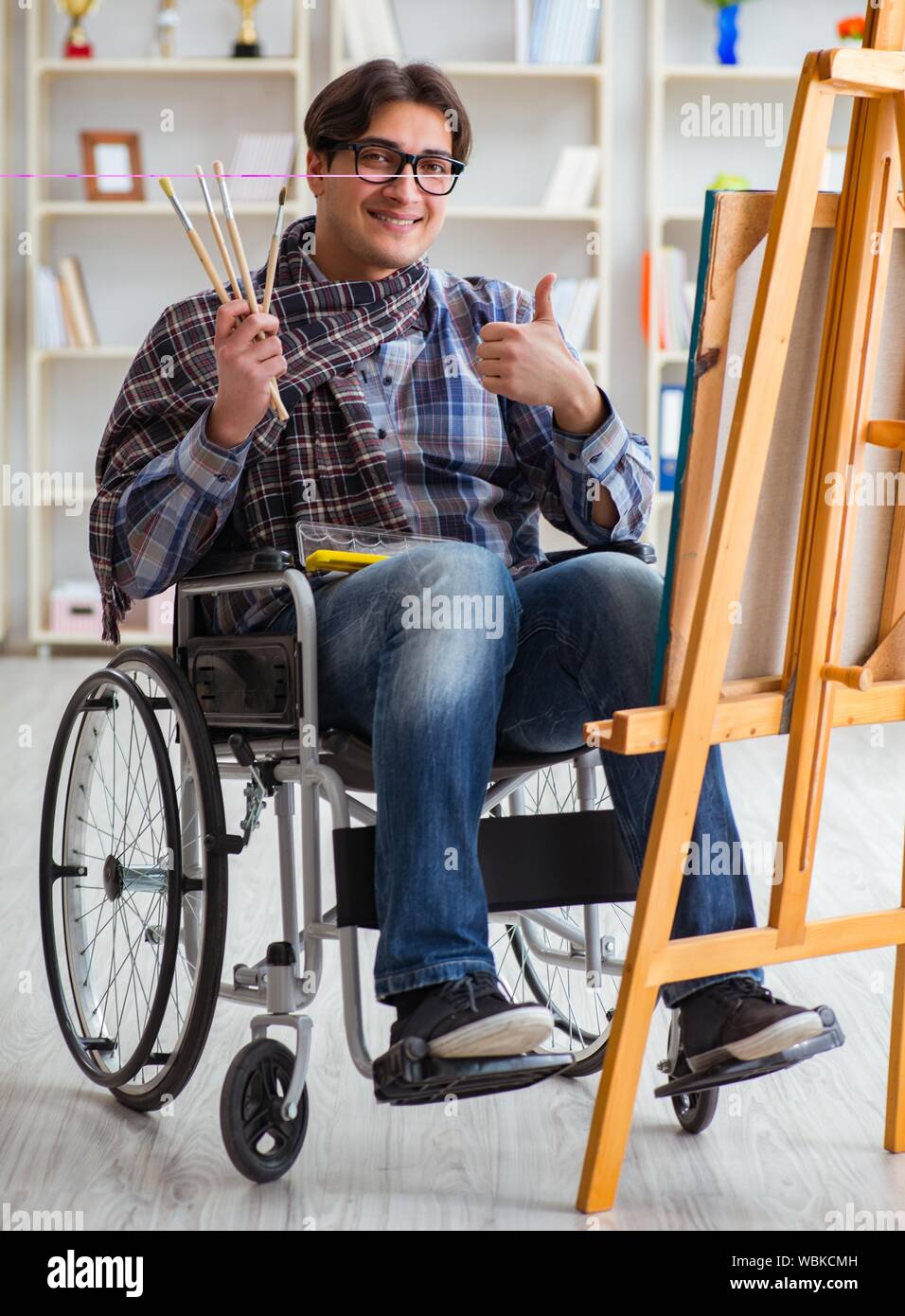 The disabled artist painting picture in studio Stock Photo - Alamy