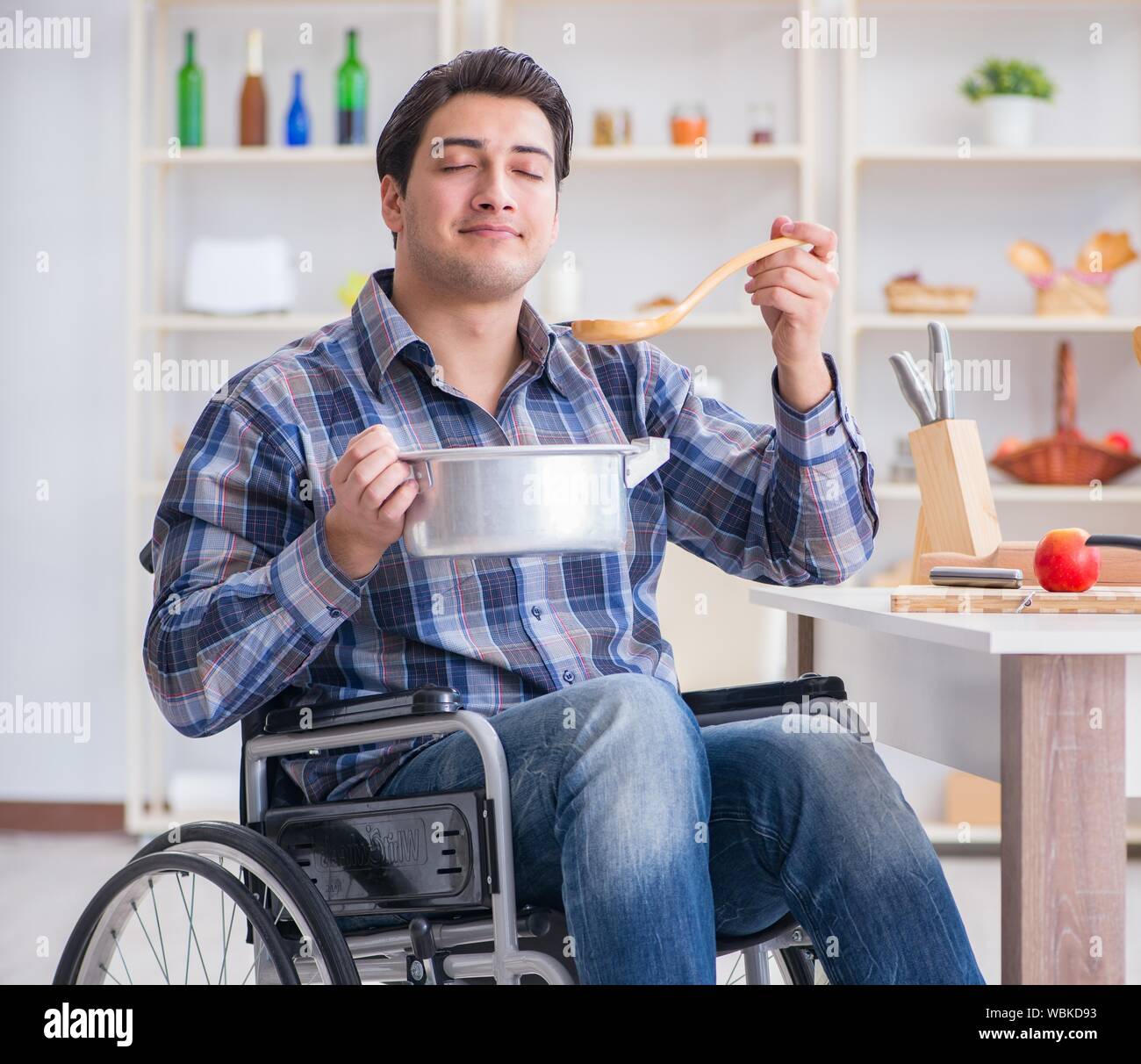 The disabled man preparing soup at kitchen Stock Photo - Alamy