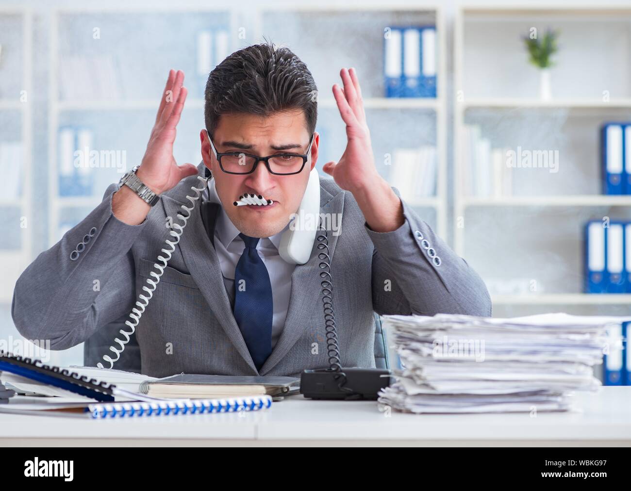 The businessman smoking in office at work Stock Photo - Alamy