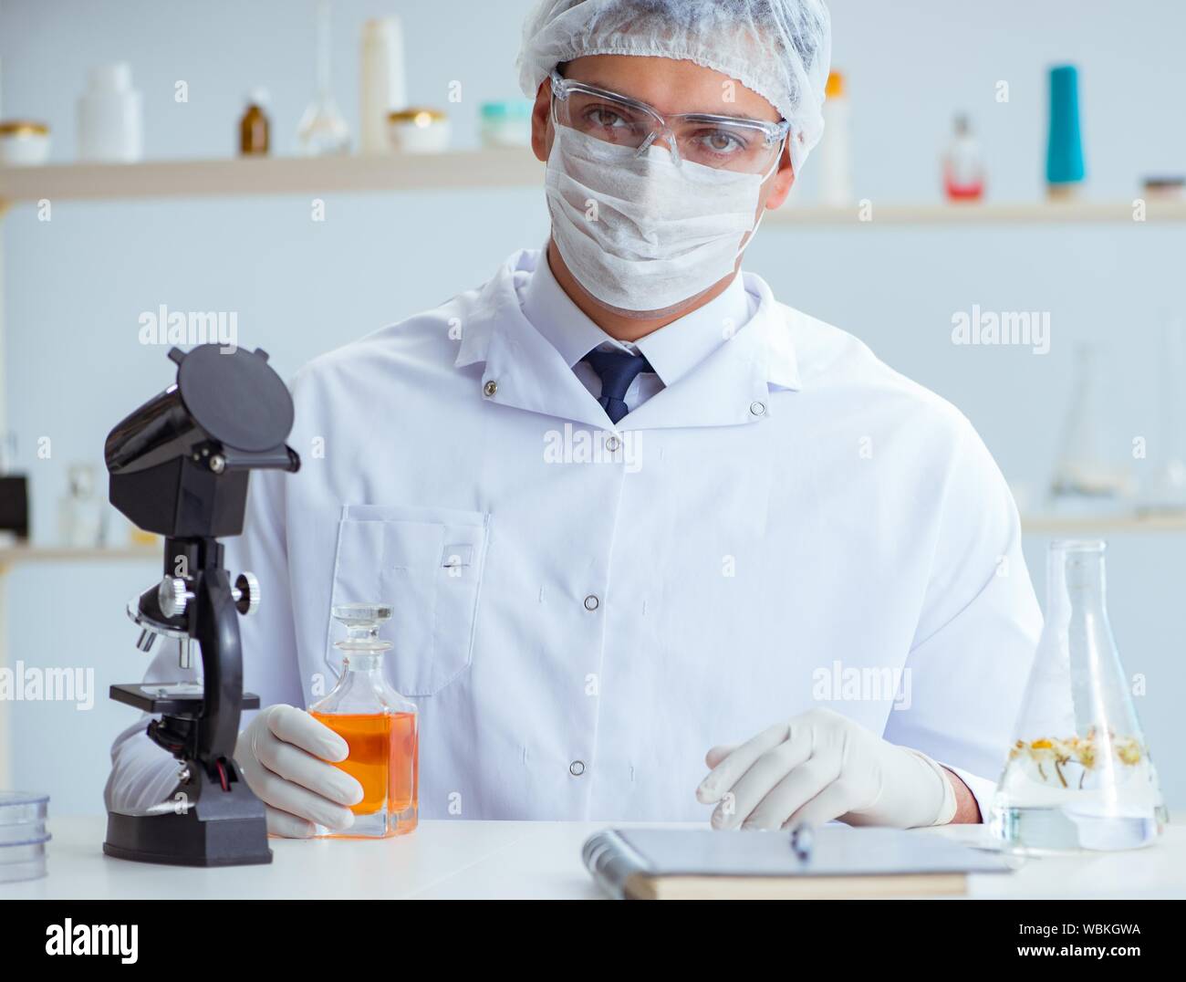 The chemist mixing perfumes in the lab Stock Photo - Alamy