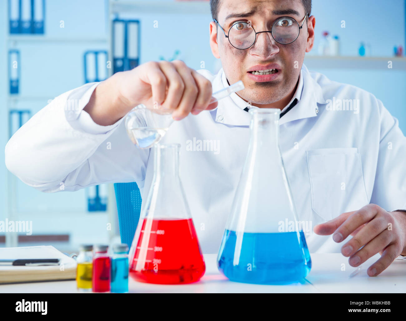 The funny mad chemist working in a laboratory Stock Photo - Alamy