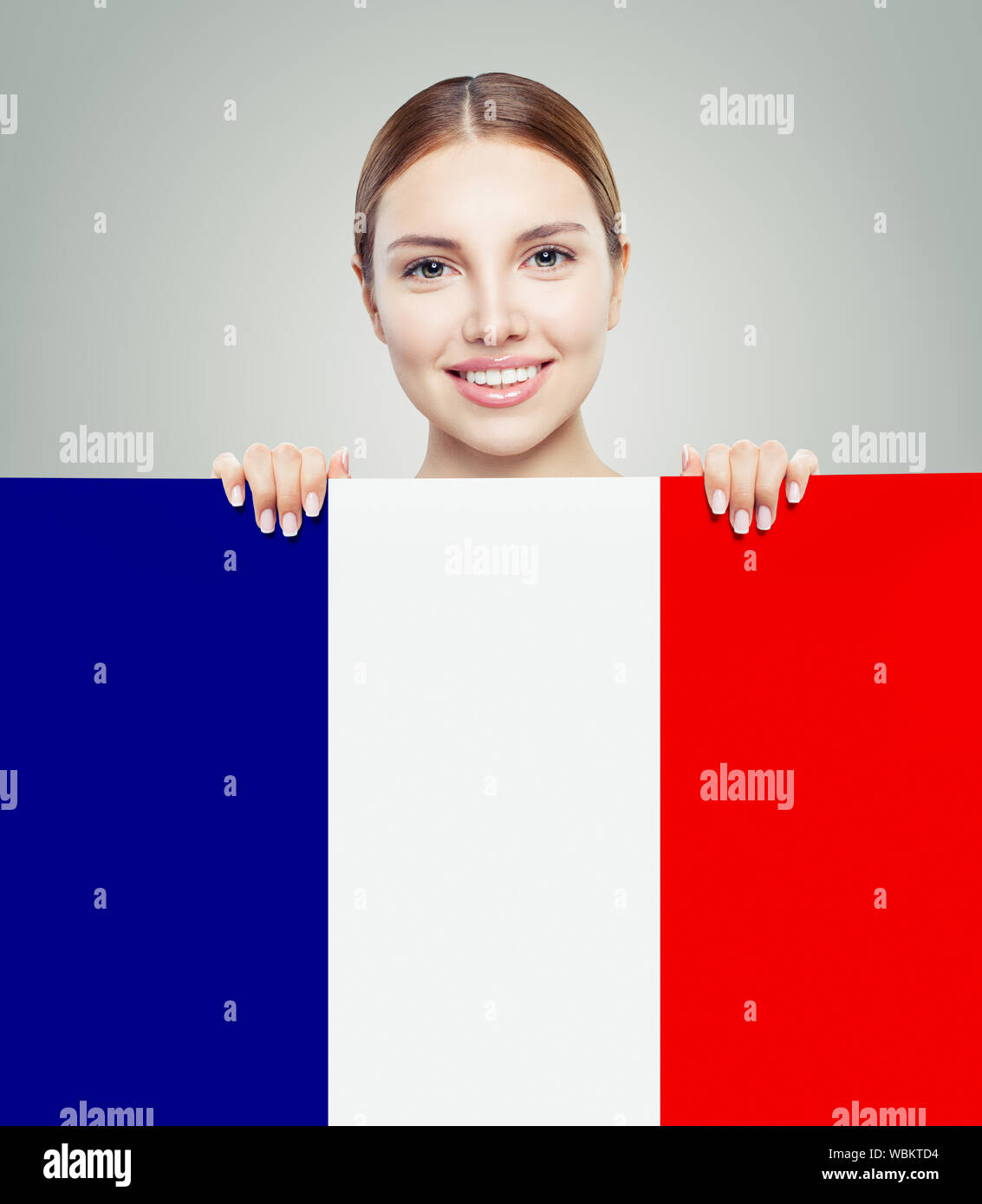 Happy woman showing French flag background. Travel in France and study ...