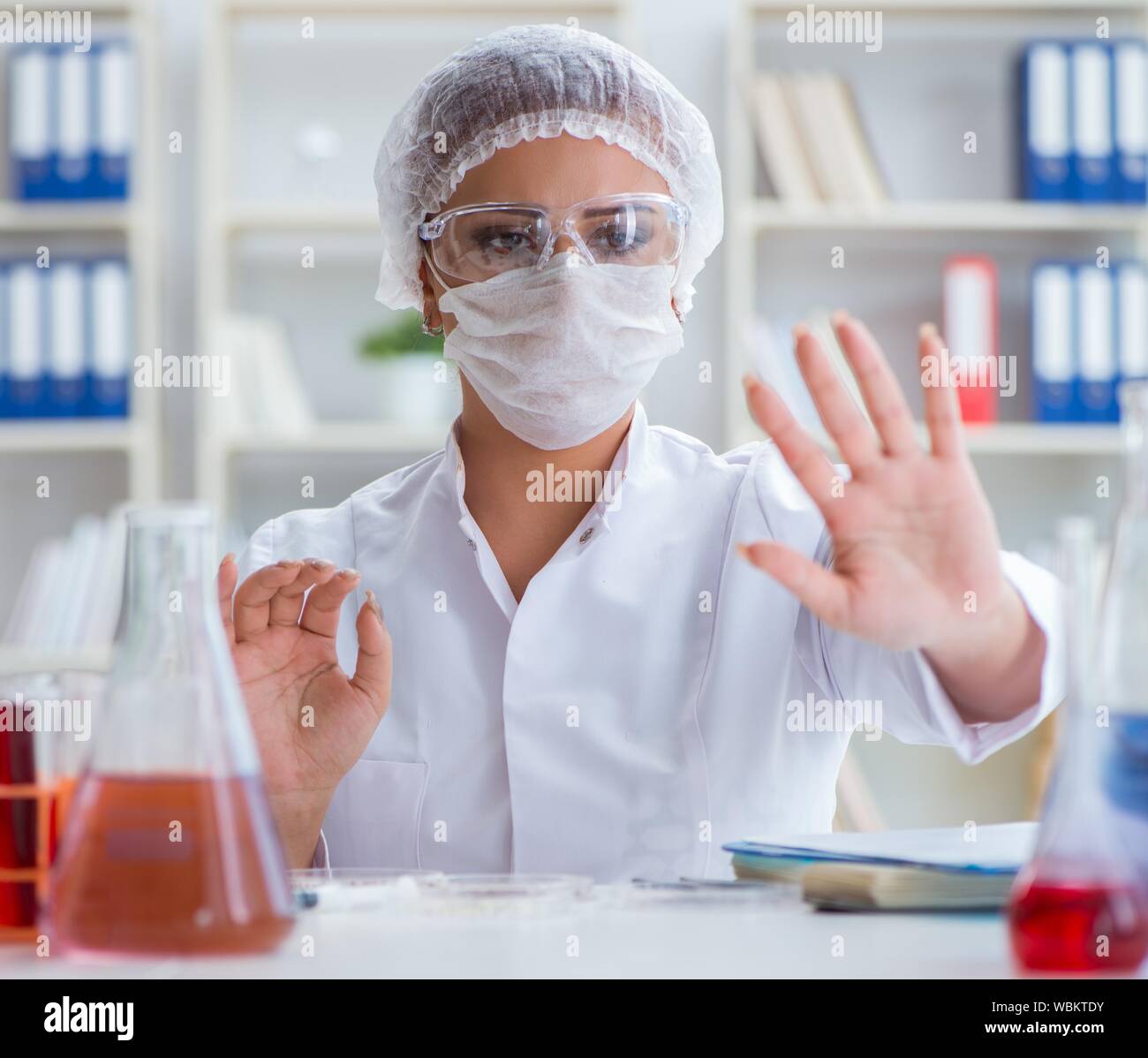 Female scientist researcher conducting an experiment in a laboratory ...