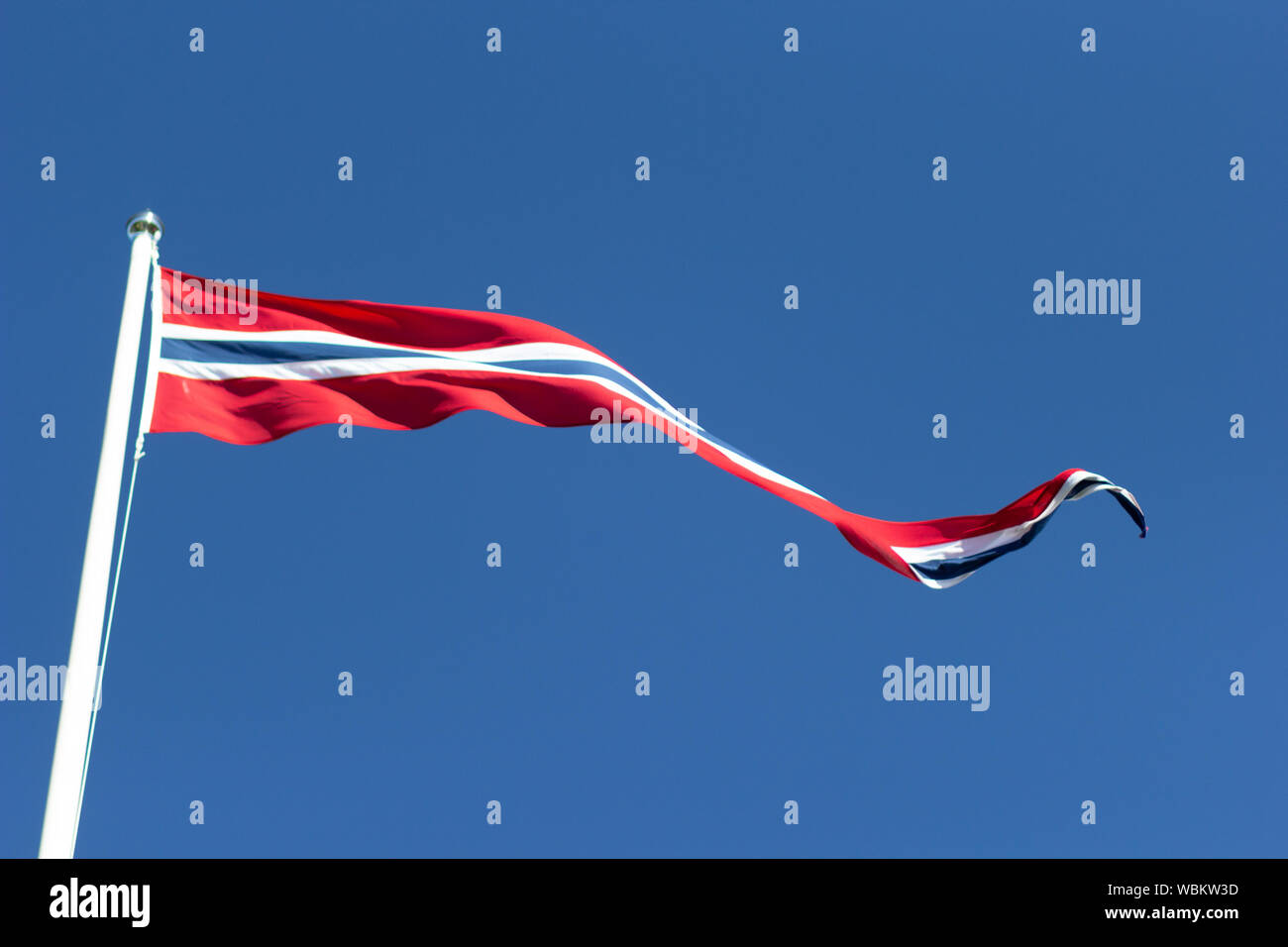 Norwegian flag flying on blue sky Stock Photo - Alamy