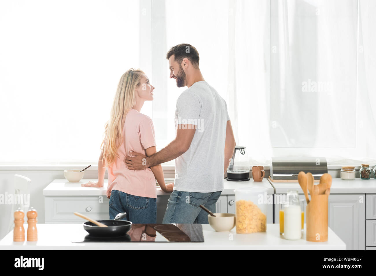 back view of beautiful couple during breakfast at kitchen Stock Photo ...