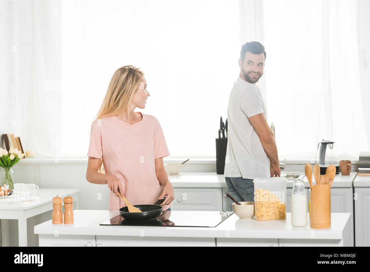 beautiful couple cooking breakfast together at kitchen Stock Photo - Alamy