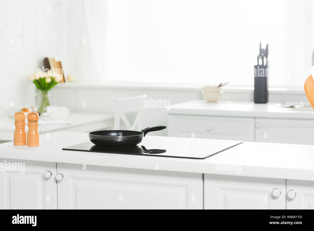 modern kitchen with white counter, cooker and frying pan Stock Photo ...