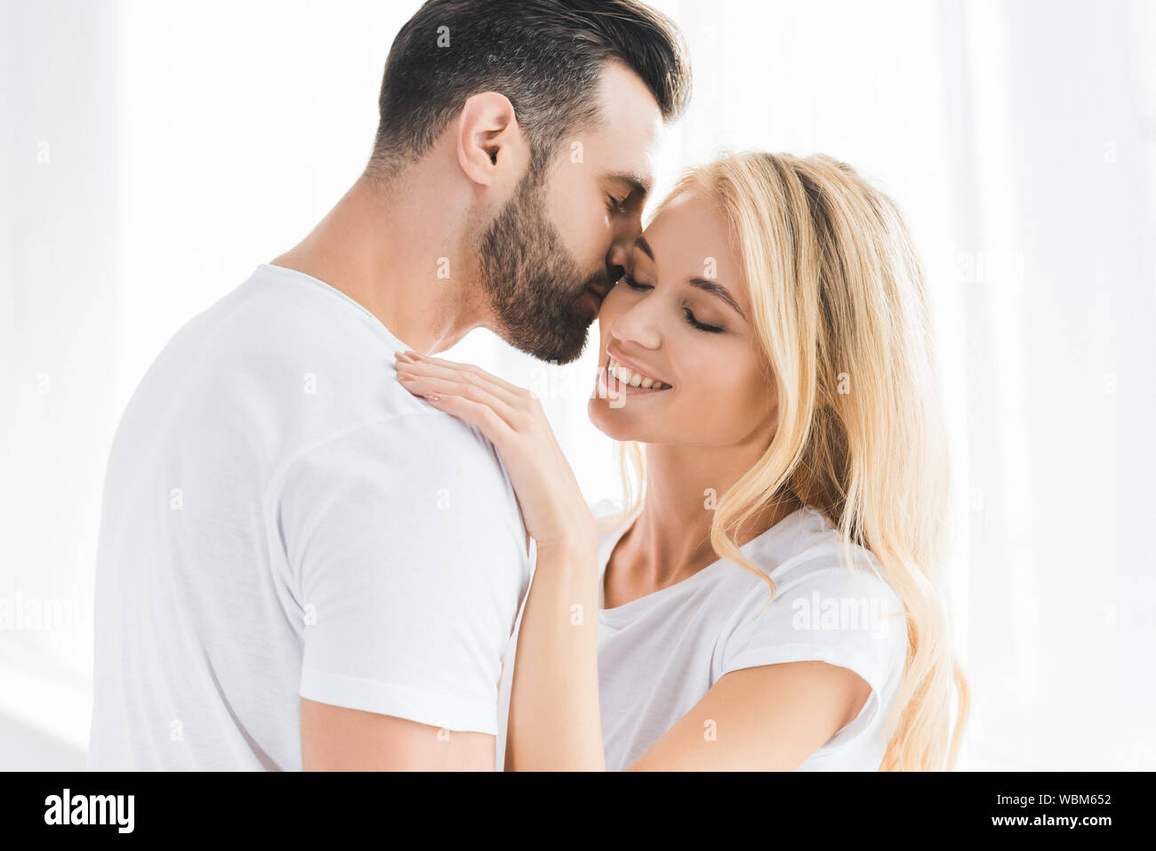 beautiful happy romantic couple embracing at home Stock Photo - Alamy