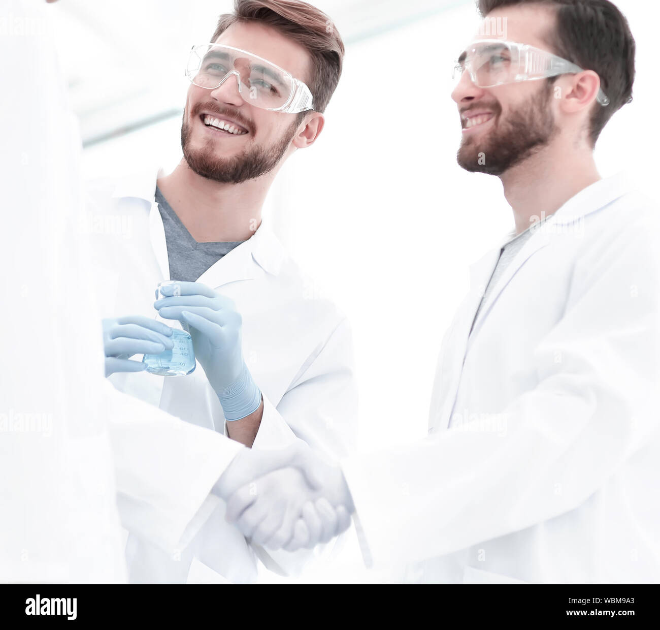 blurred image of a handshake between scientists Stock Photo - Alamy