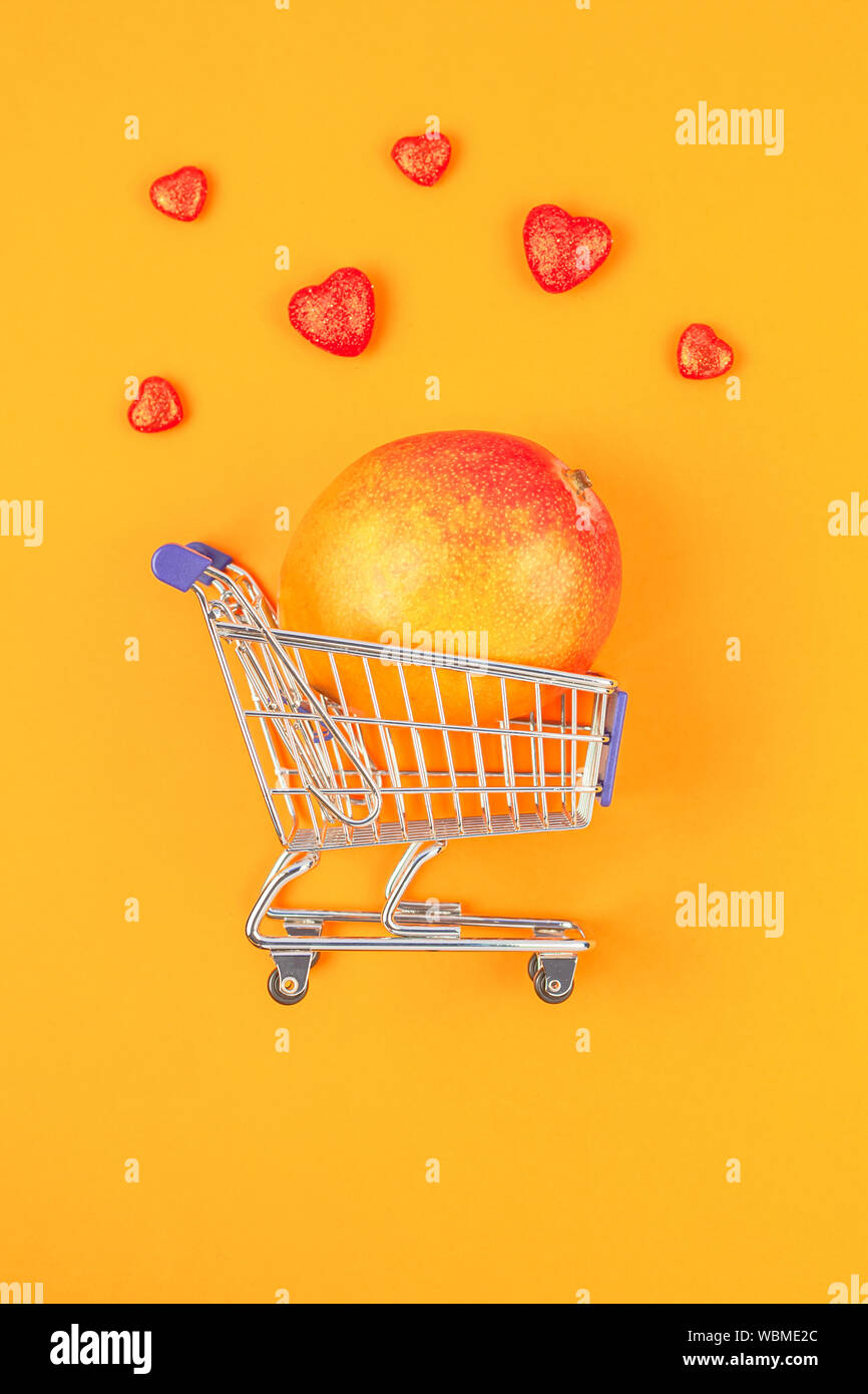Mango fruit in shopping cart in creative conceptual top view flat lay ...