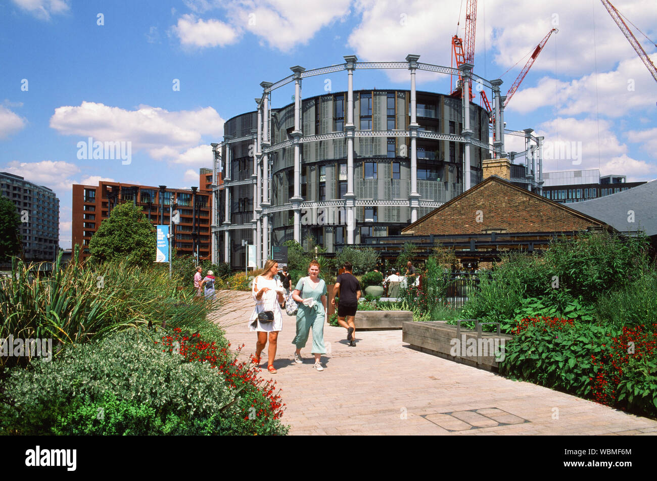 Pedestrians on a footpath in the new Gasholder Park development near ...