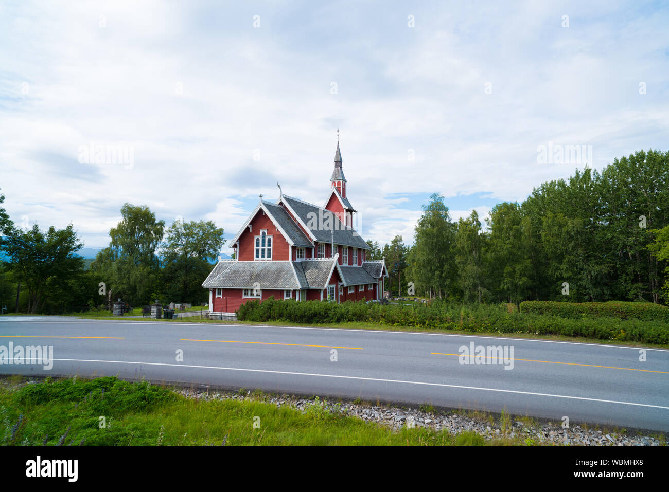Veøy Church, a red, wooden church, built in a long church design in the ...