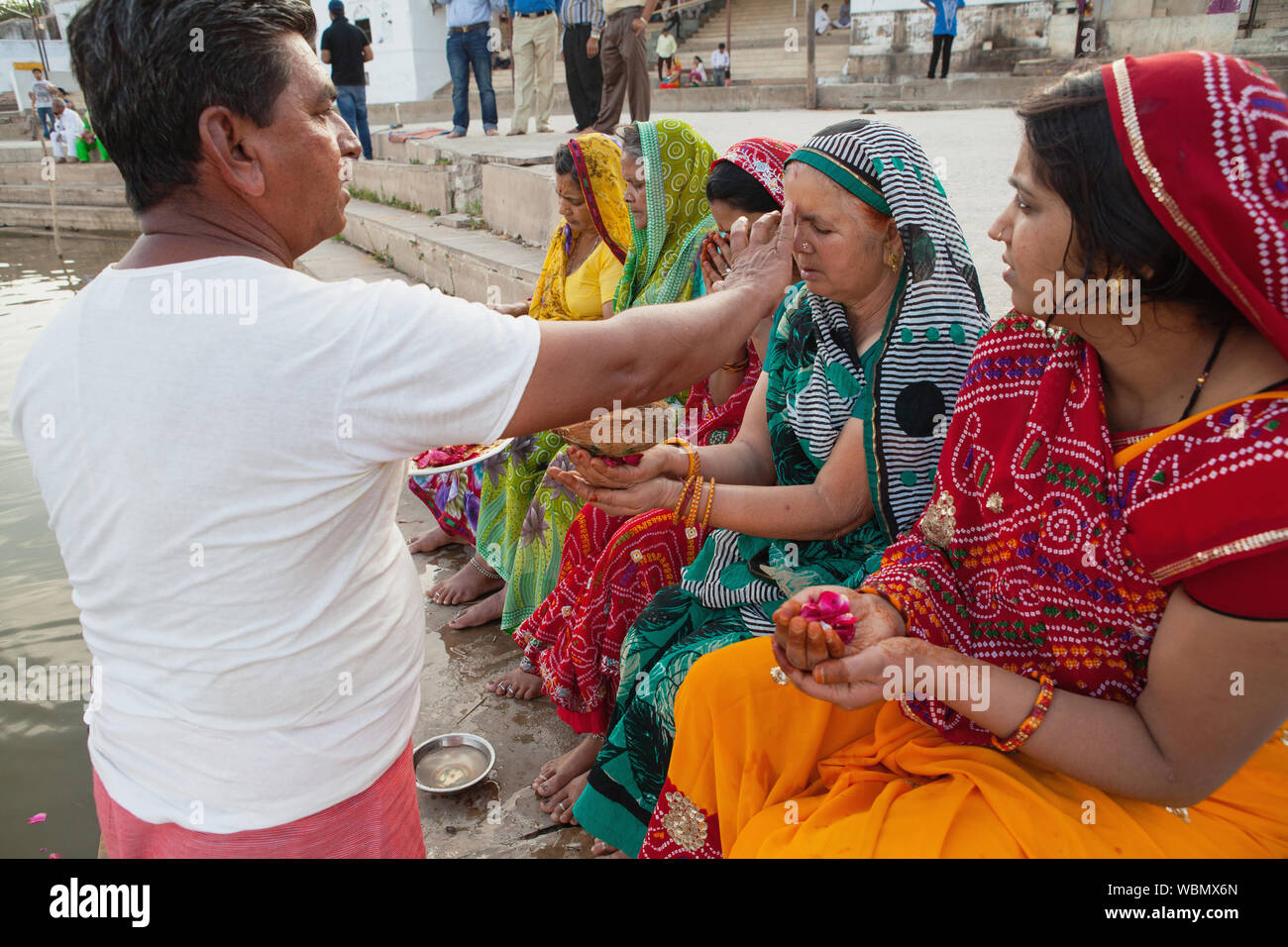 India, Rajasthan, Pushkar, A pandit conducts a puja on the ghats of ...