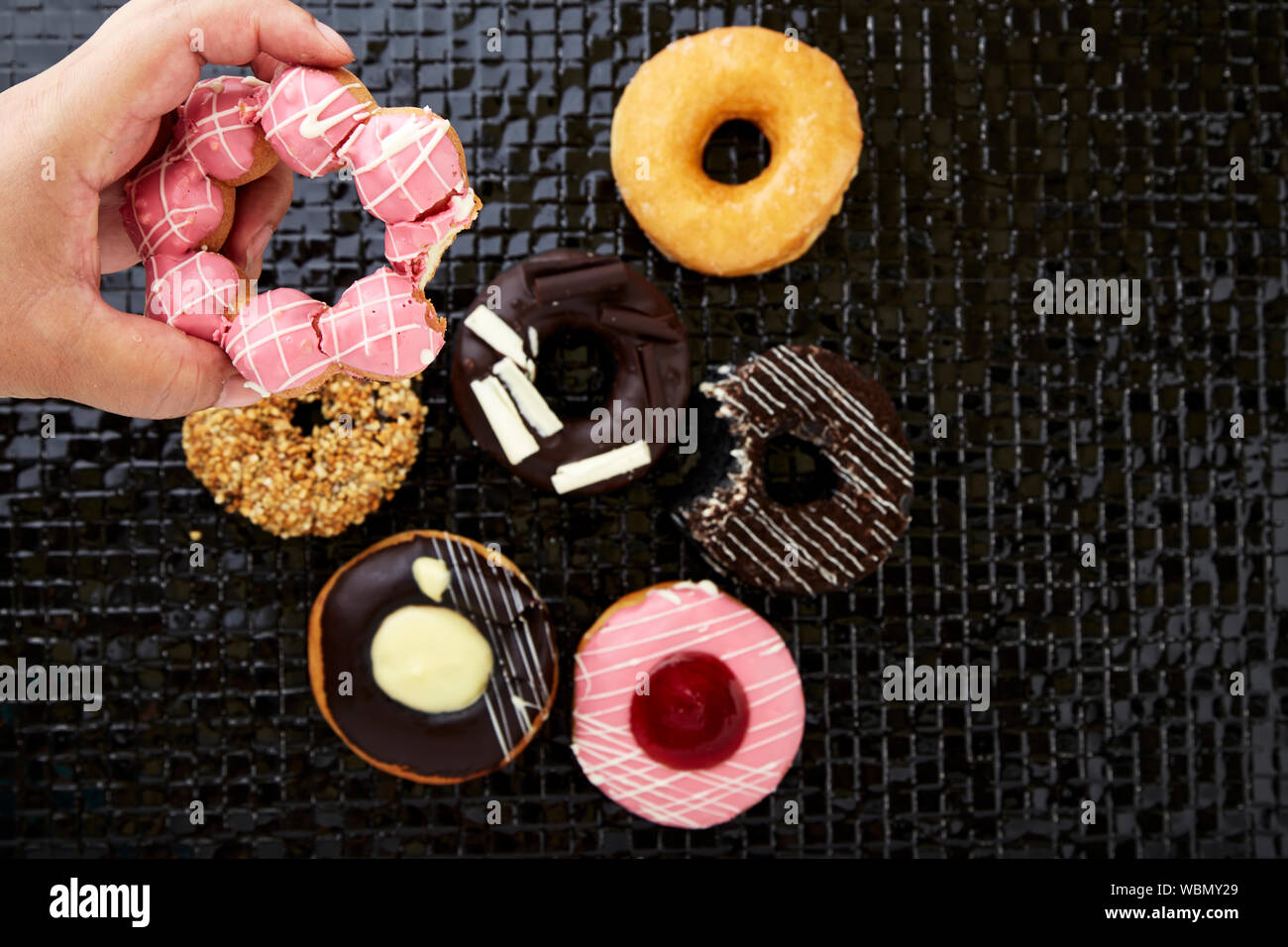 Hand holding donut hi-res stock photography and images - Alamy