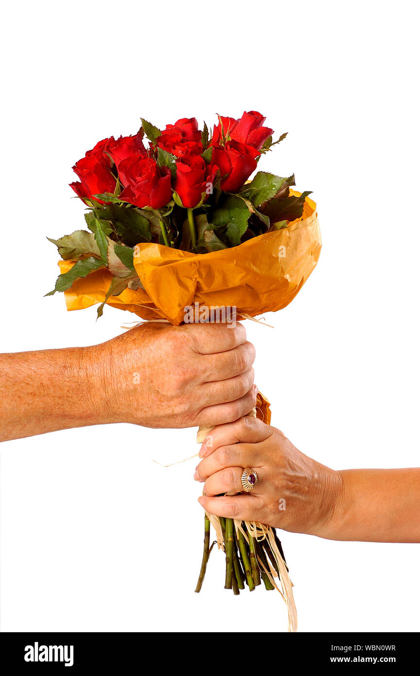 A women receiving red roses from a man Stock Photo - Alamy