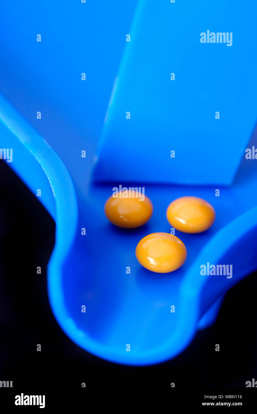Three tablets on a blue pill counter Stock Photo - Alamy