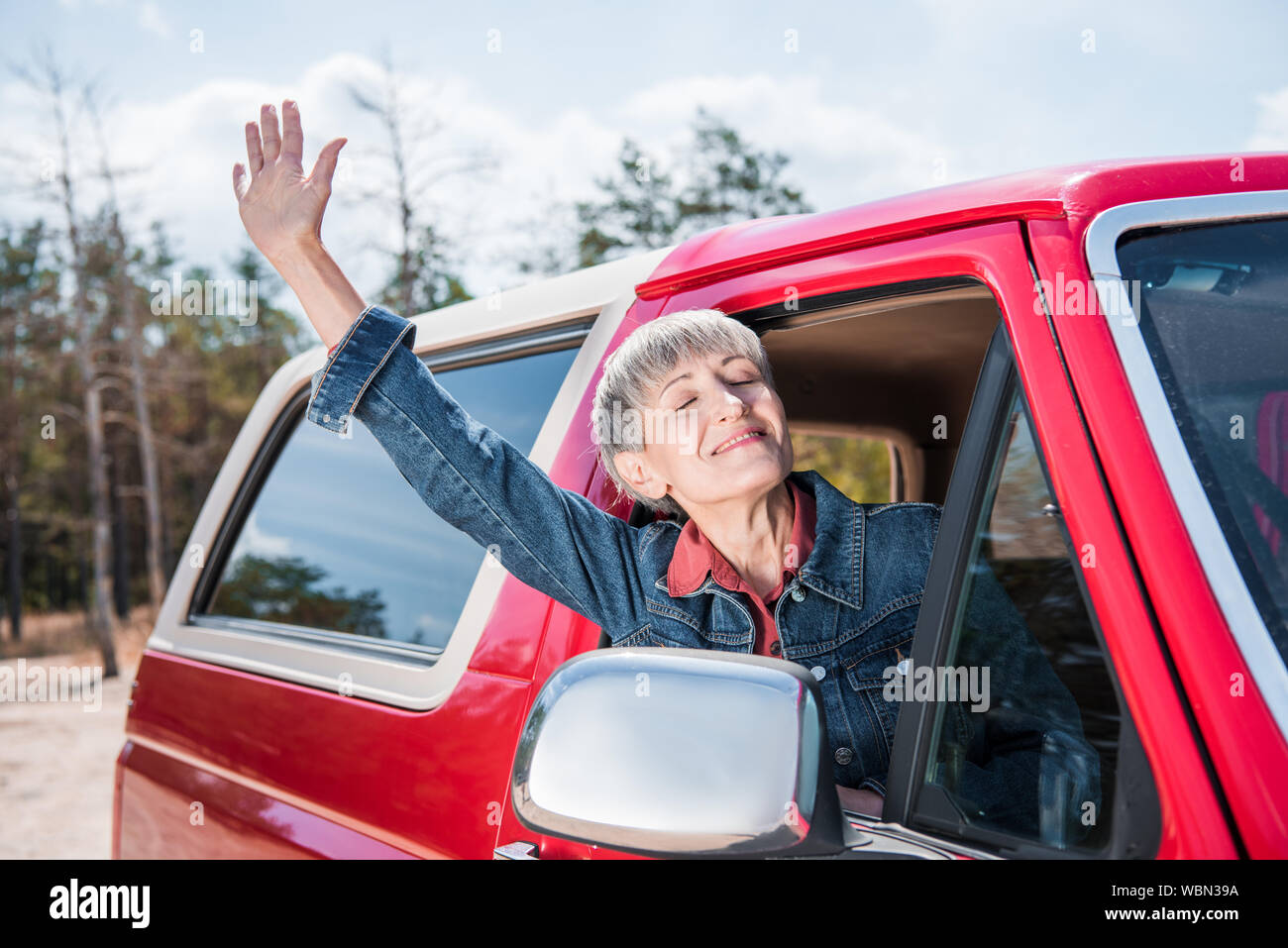 People Waving From Car