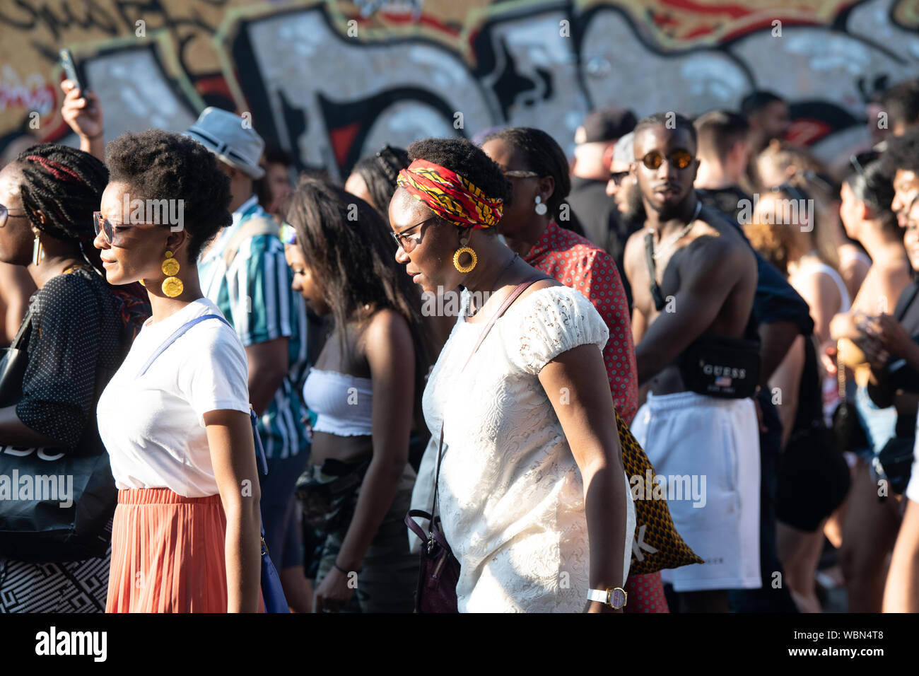 Two black women walking through a crowd at Notting Hill Carnival ...