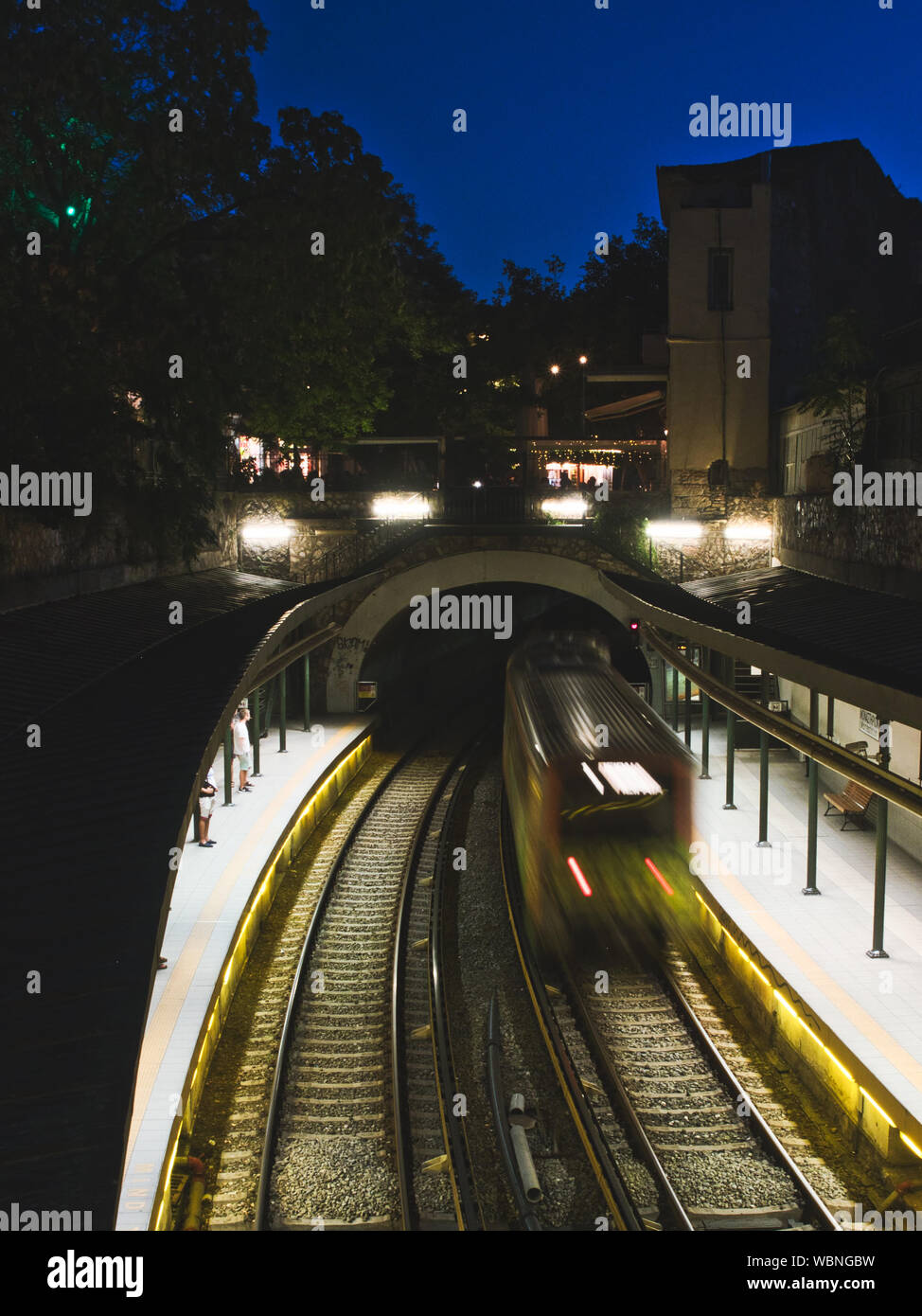 Metro train leaves the Acropolis subway station in historical center at ...