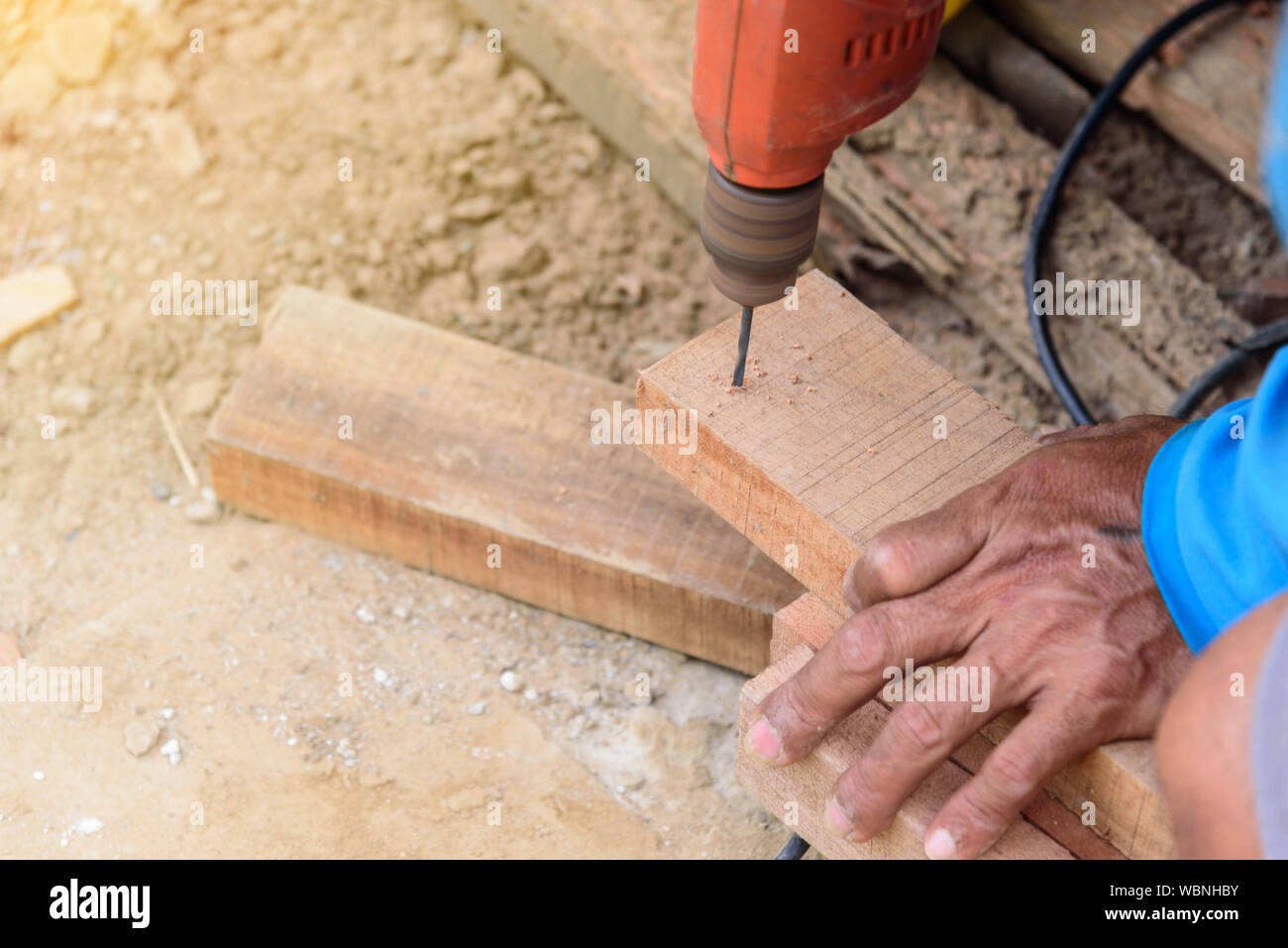 carpenter drill the wood by drill machine Stock Photo - Alamy