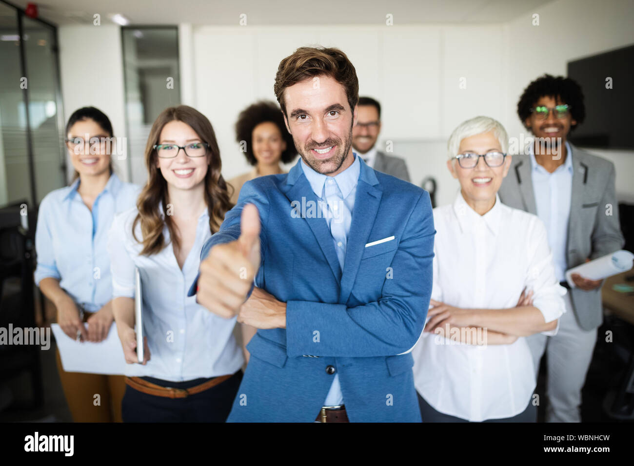 Successful company with happy workers in office Stock Photo - Alamy