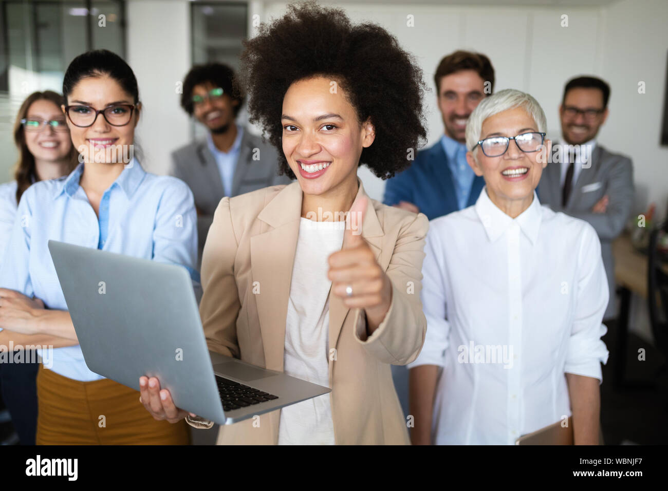 Happy business colleagues in modern office working together Stock Photo ...