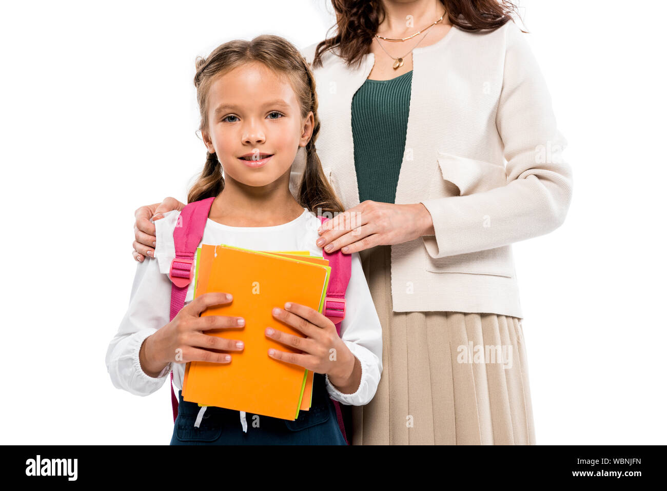 cropped view of mother touching shoulders happy daughter isolated on ...