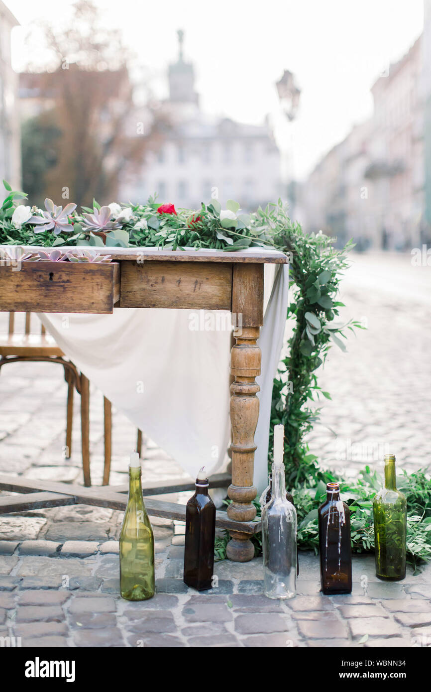 Wooden table and chairs decorated with flowers, succulents and decor ...