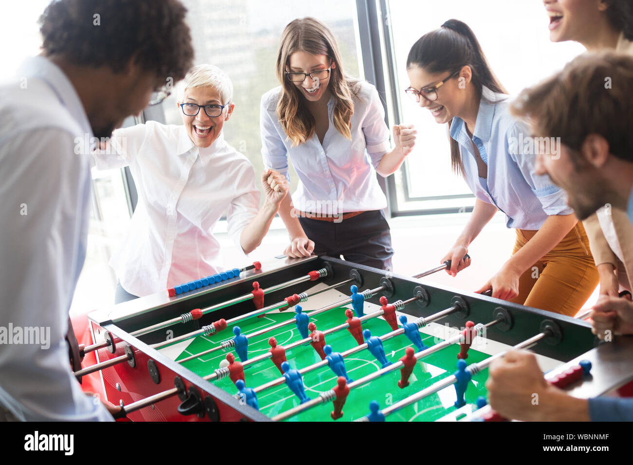 Business people having great time together.Colleagues playing table ...