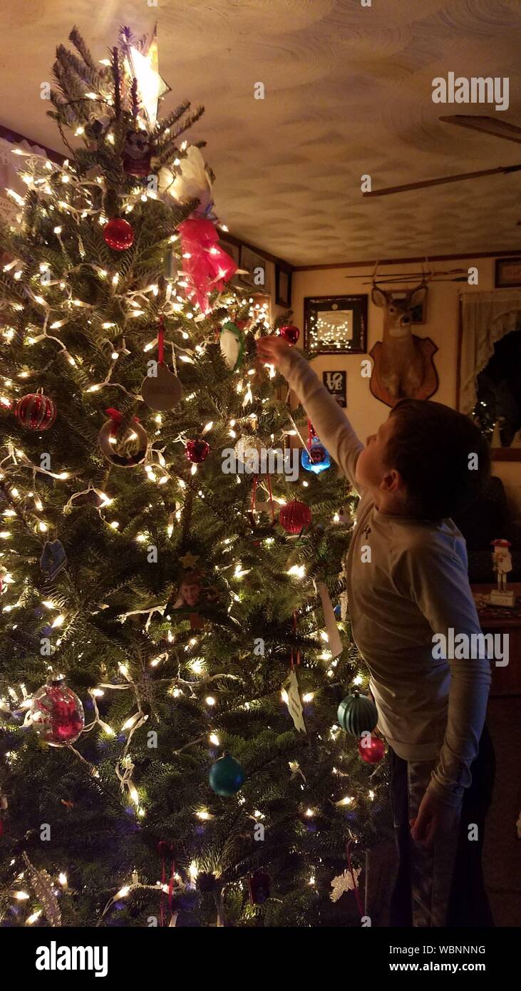 Boy by the christmas tree hi-res stock photography and images - Alamy