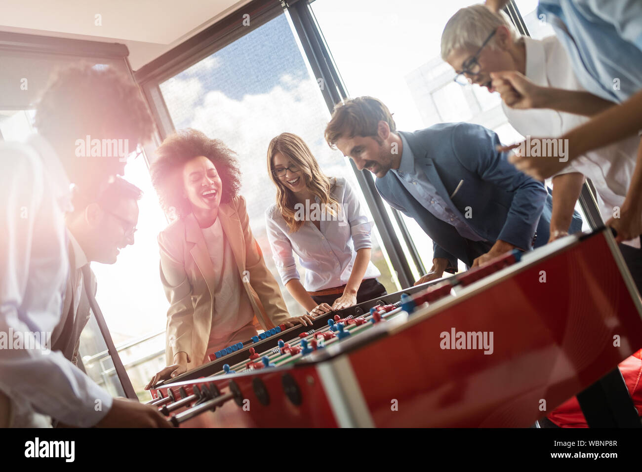 Multiracial people having fun in office room, excited diverse employees ...