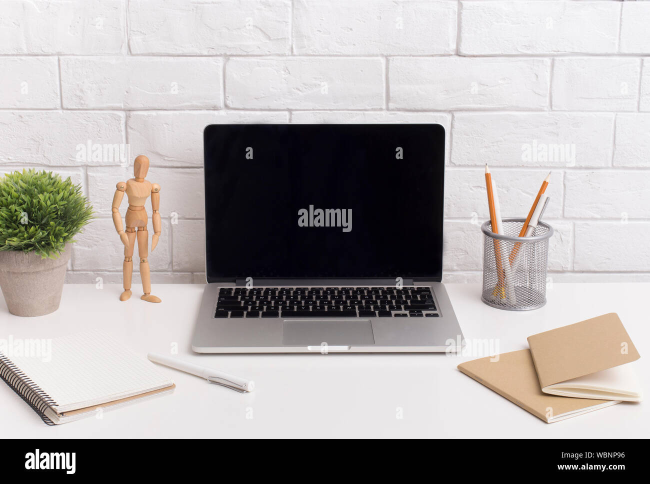 Stylish Laptop with blank screen and office supplies on white Stock ...