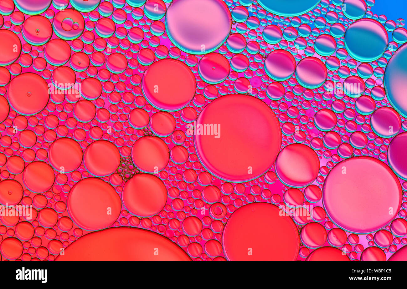 Multi-coloured bubble patterns formed by oil floating on water Stock ...