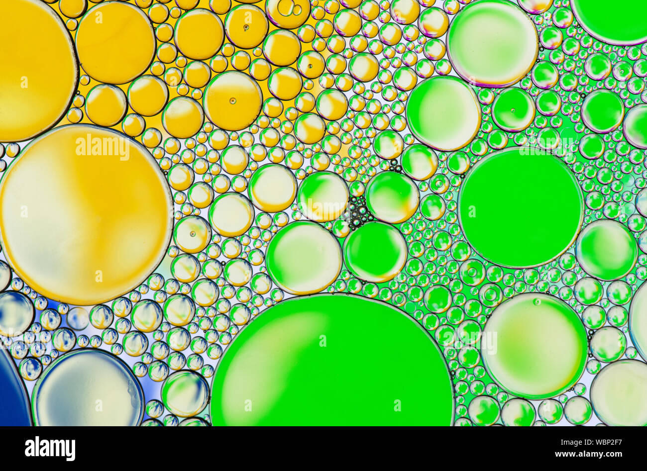 Multi-coloured bubble patterns formed by oil floating on water Stock ...