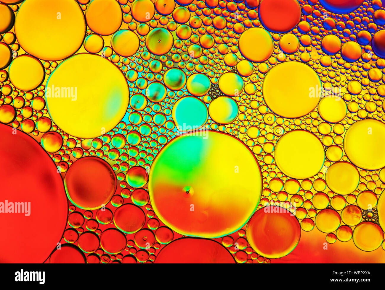 Multi-coloured bubble patterns formed by oil floating on water Stock ...