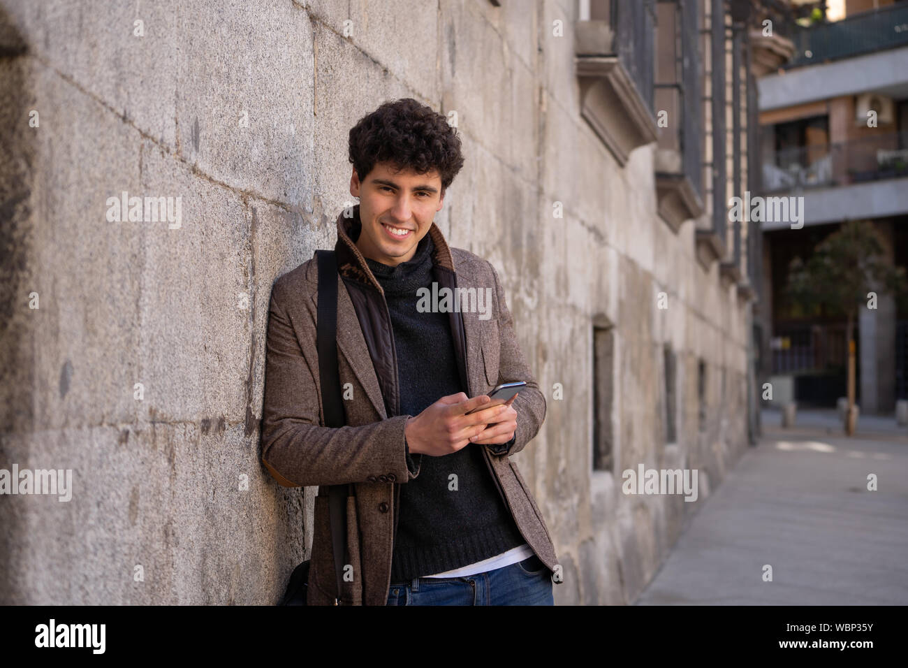 Fashion college man in his twenties happy checking blog or chatting on ...