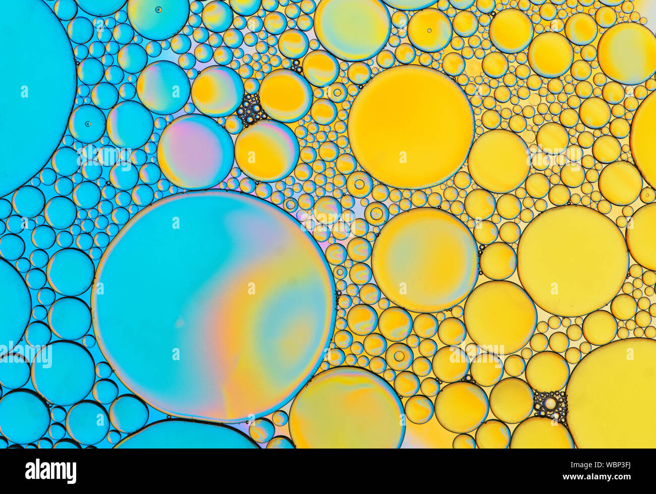 Multi-coloured bubble patterns formed by oil floating on water Stock ...